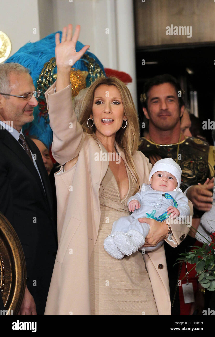 Singer Celine Dion holds her son Nelson Angelil next to her husband and ...