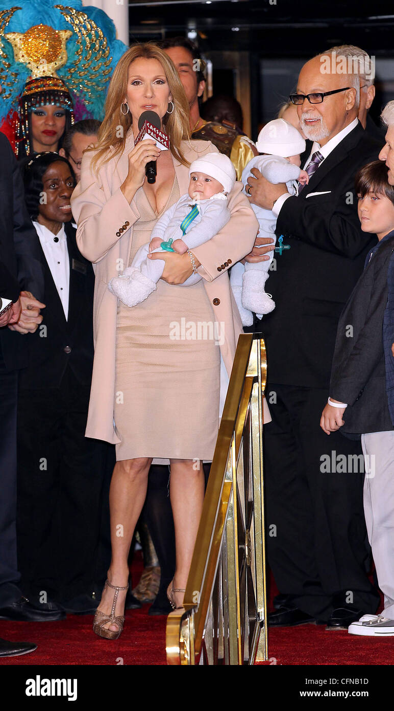 Singer Celine Dion holds her son Nelson Angelil next to her husband and ...