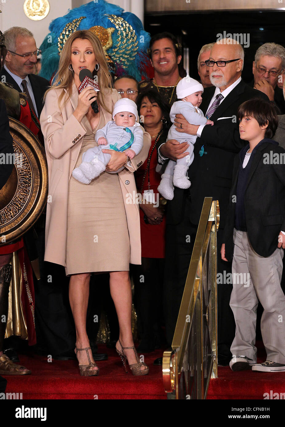 Singer Celine Dion holds her son Nelson Angelil next to her husband and ...