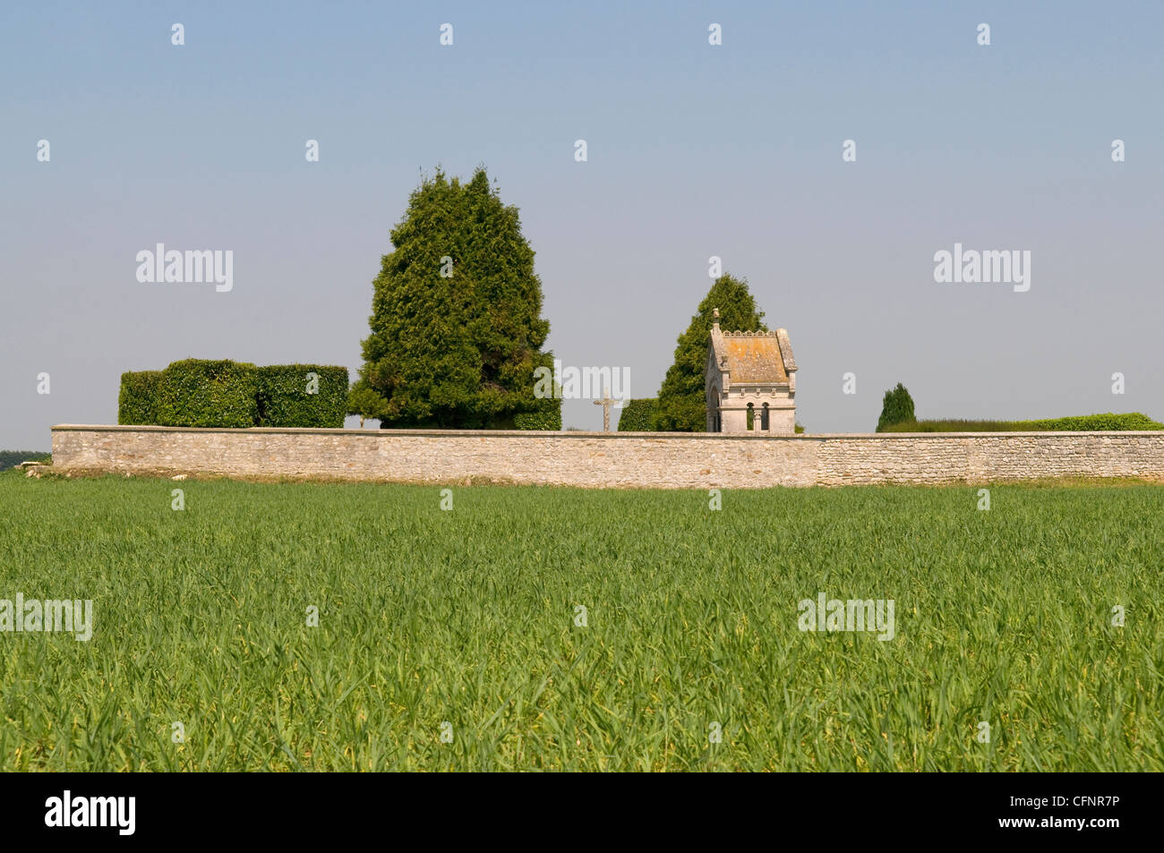 Small graveyard in a rural field surrounded by stone wall in Maudétour ...