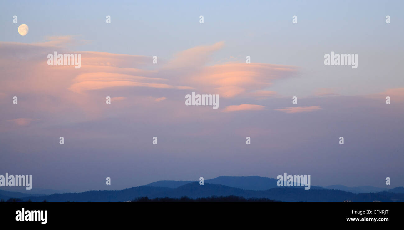 Lenticular cloud formation (Altocumulus lenticularis) at sunrise with ...