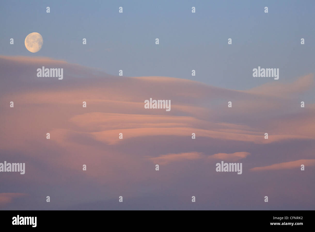 Lenticular cloud formation (Altocumulus lenticularis) at sunrise with ...