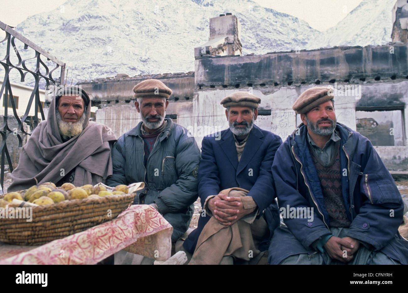 Pakistani men sitting in the street of the town of Gilgit in Hunza ...