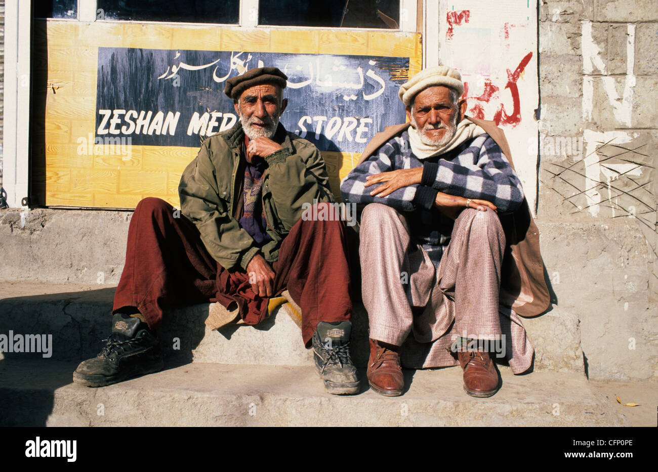 Portrait of two old pakistani men sitting on streets of Gilgit, Hunza ...