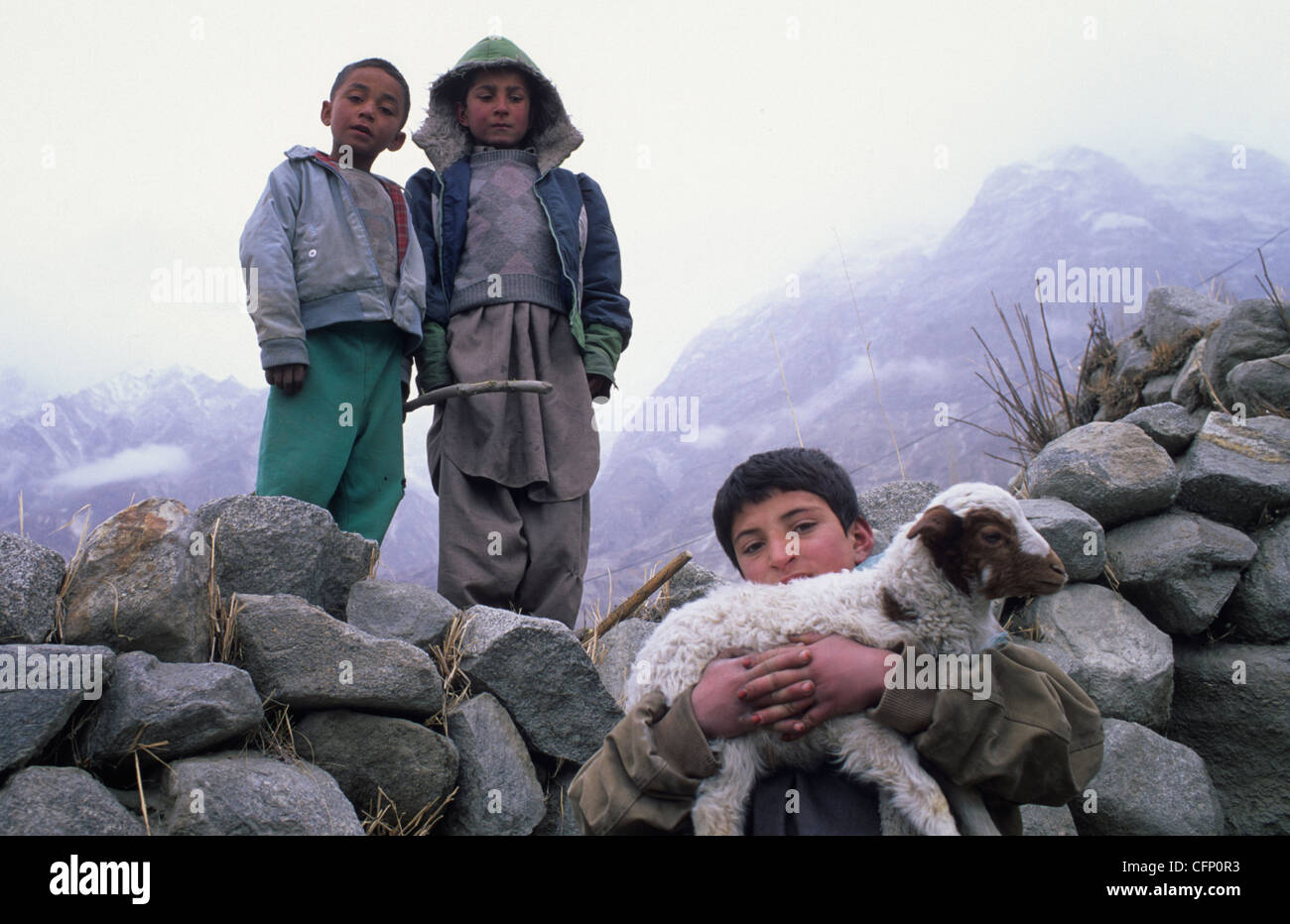 Three shepherd children on the outskirts of the village of Karimabad ...