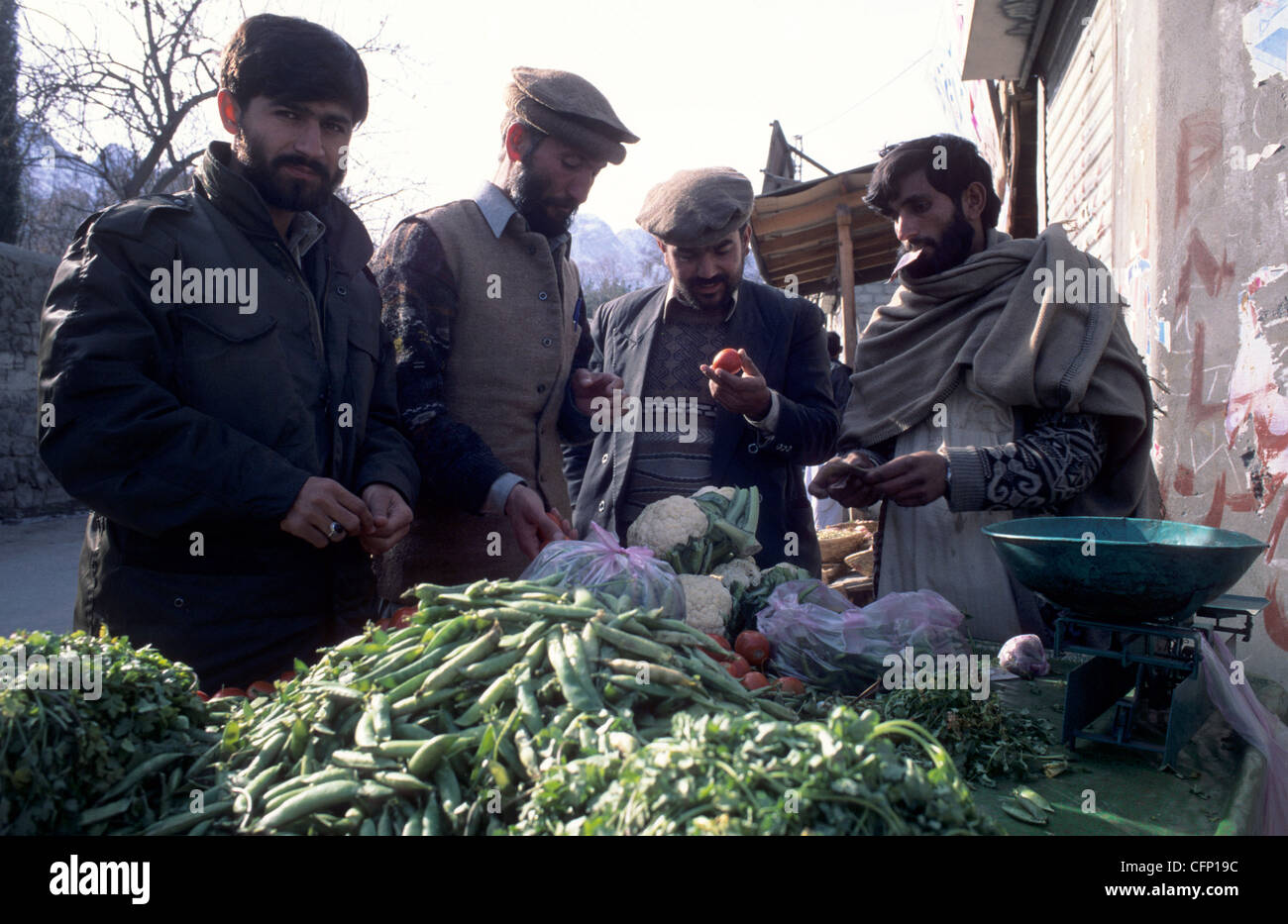 Pakistani men standing around a vegetable market in Gilgit, Hunza ...