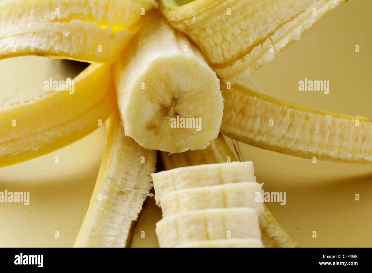 ripe banana cut into slices on a gold background Stock Photo - Alamy