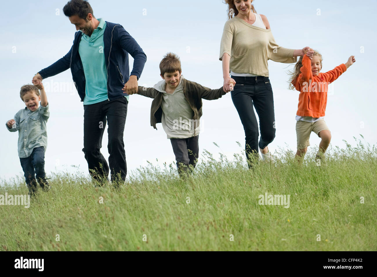 Two children holding hands running down hi-res stock photography and ...