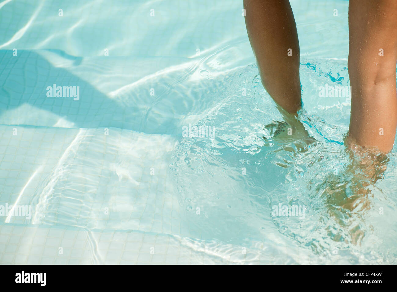 Woman wading in pool, cropped Stock Photo - Alamy