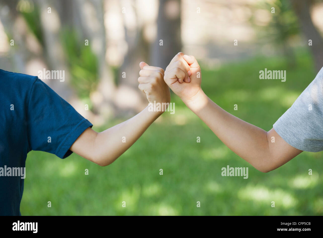 Boy bumping fists friend cropped hi-res stock photography and images ...