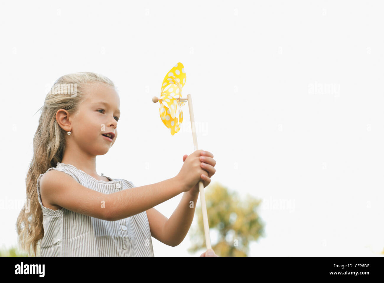 Little girl holding pinwheel Stock Photo - Alamy