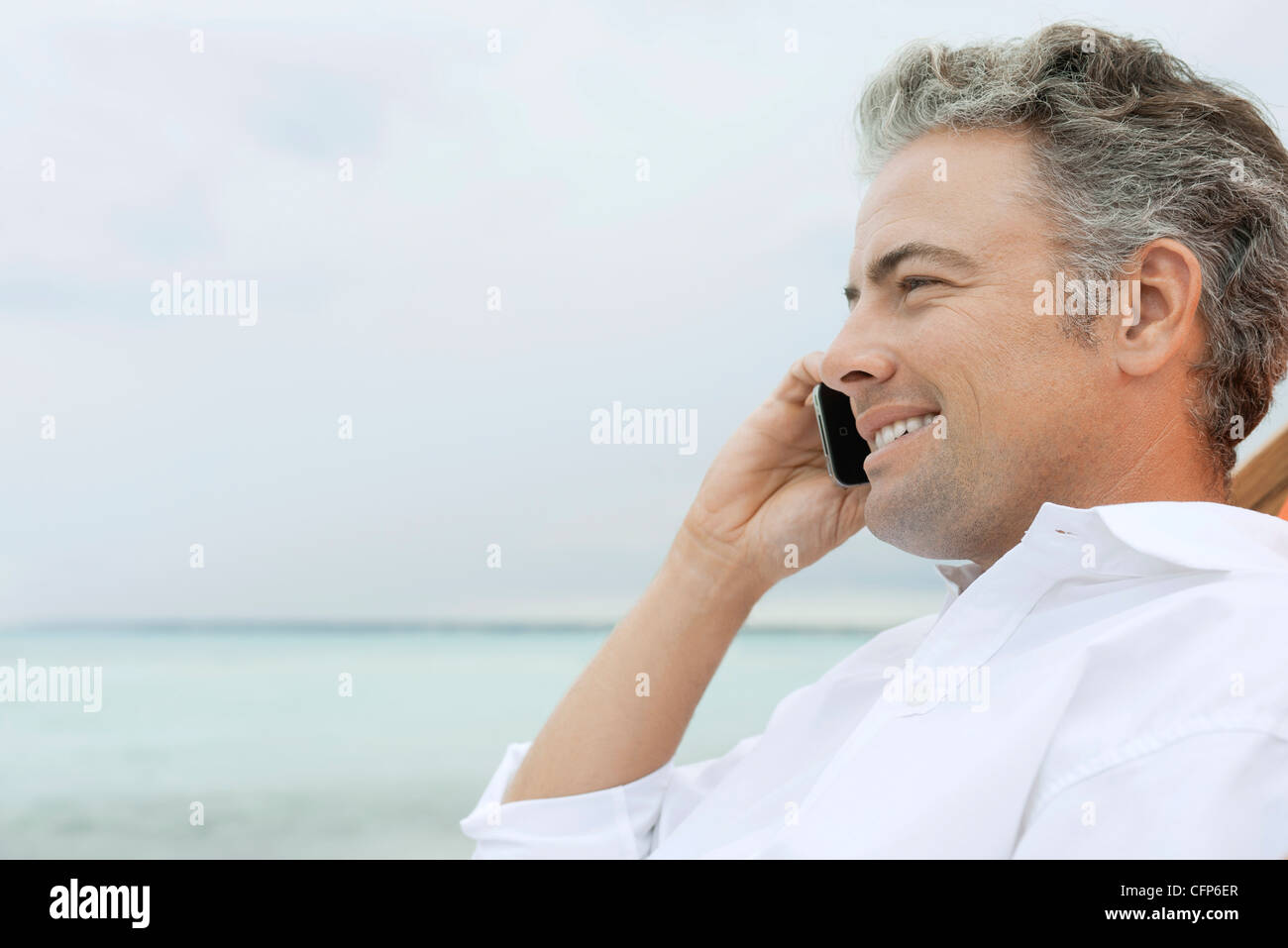 Man talking on cell phone at the beach Stock Photo - Alamy