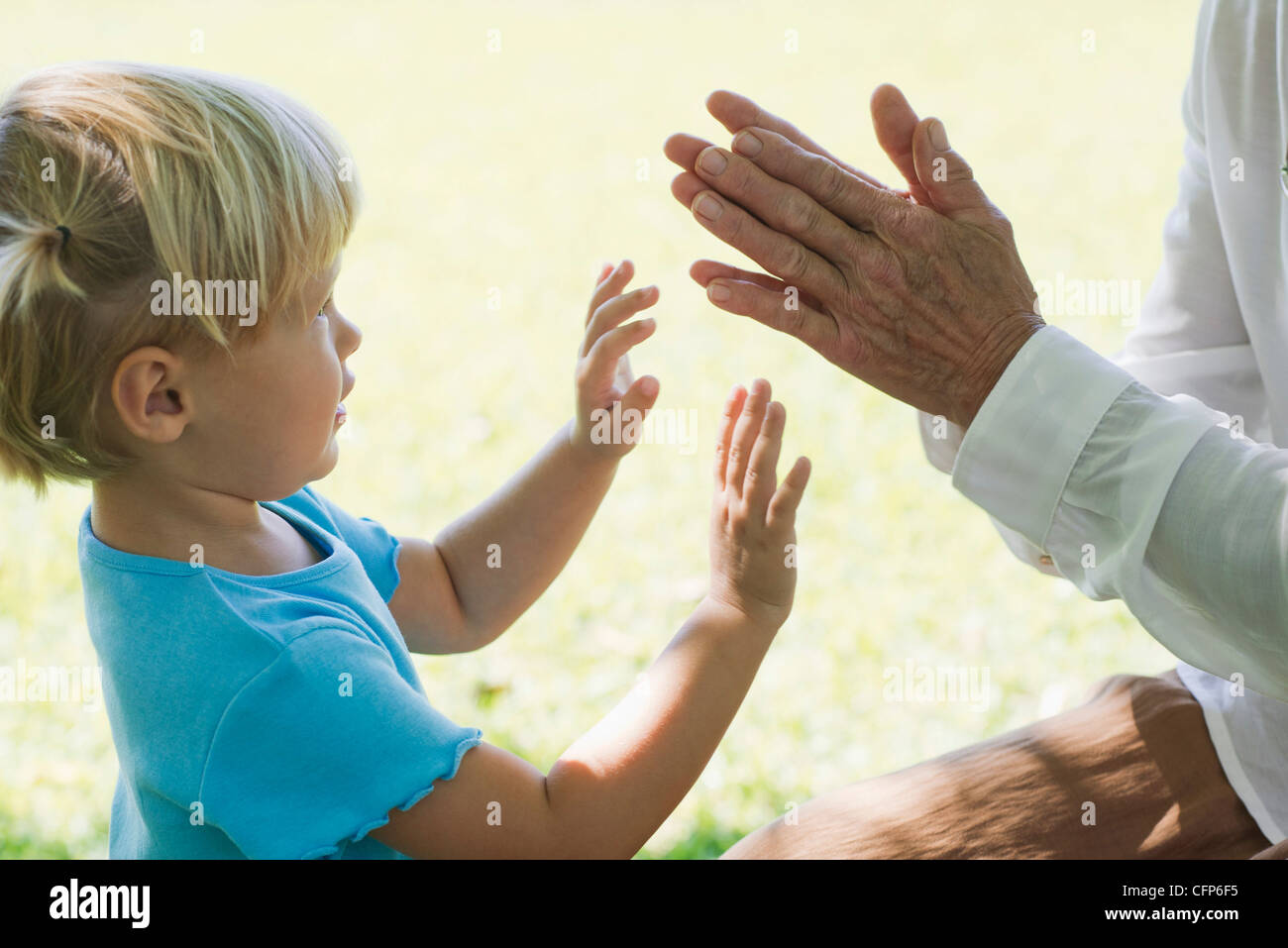 Little girl playing clapping game with grandmother, cropped Stock Photo ...