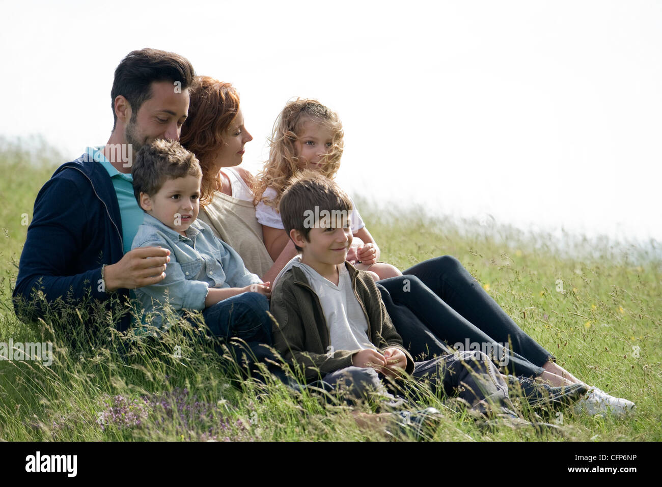 Family relaxing together outdoors Stock Photo - Alamy