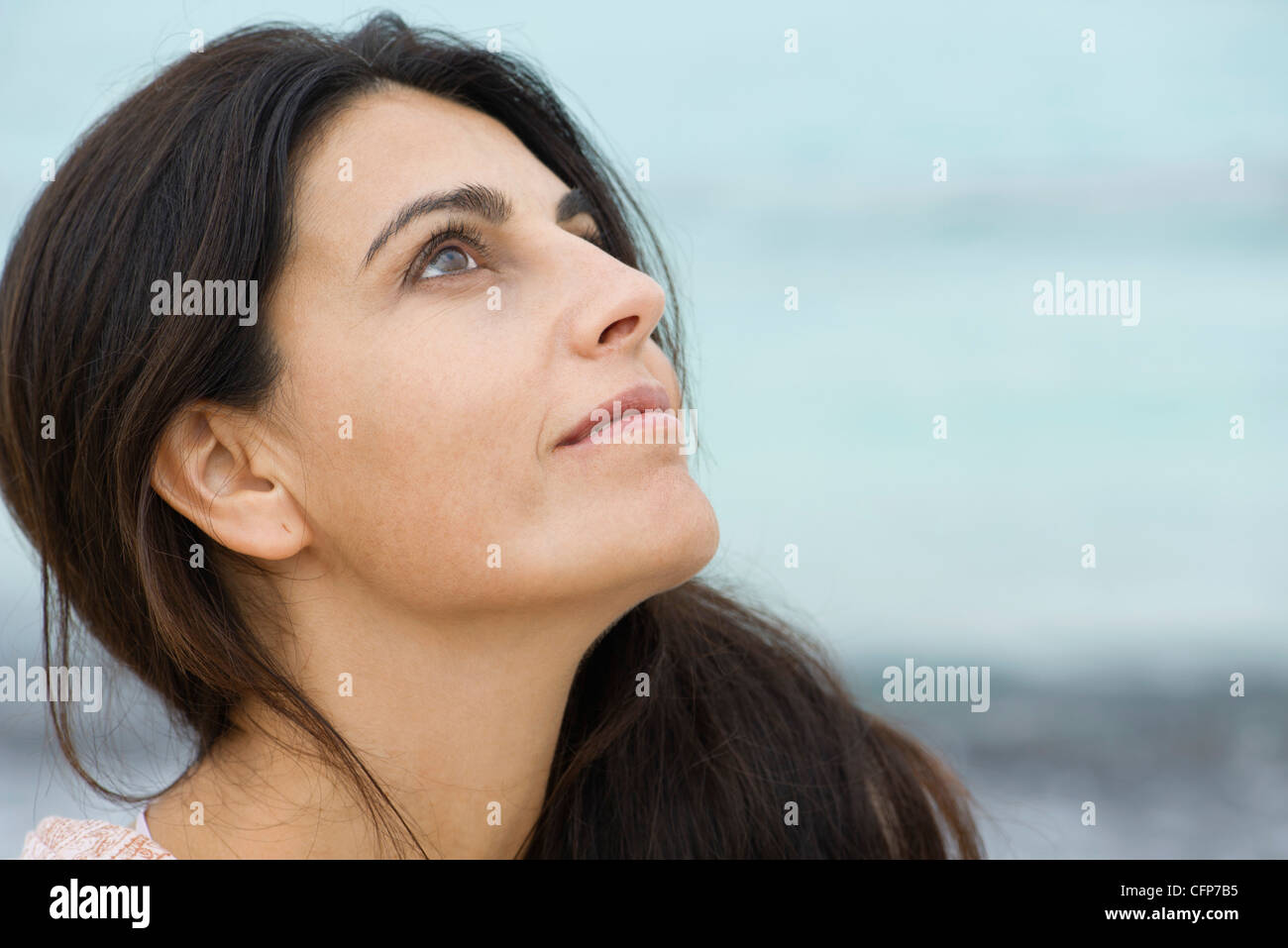 Woman looking up in thought, portrait Stock Photo - Alamy