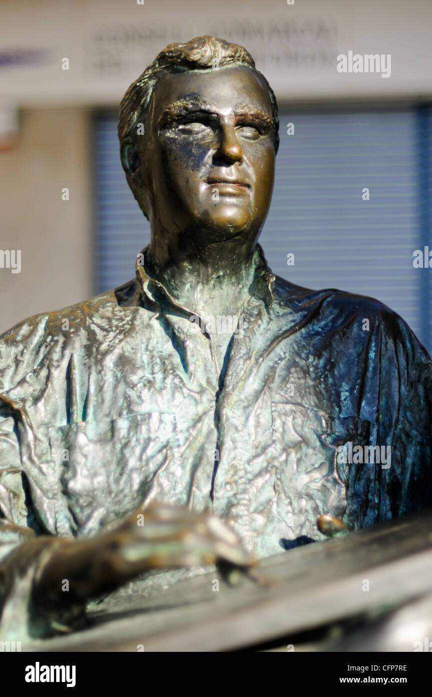 A statue of a man reading on a sunny day in Palamos, Costa Brava Stock ...