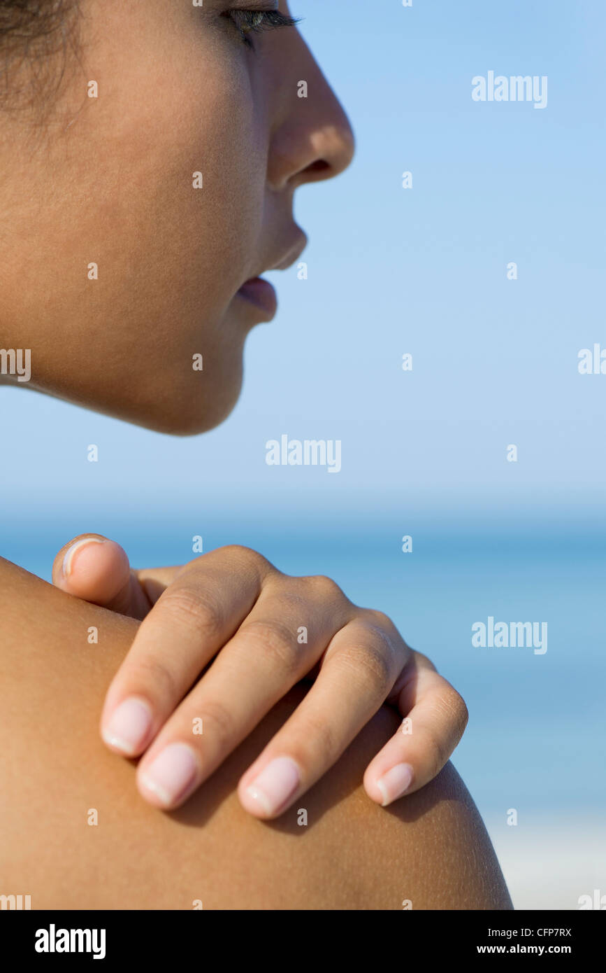 Woman touching bare shoulder, cropped Stock Photo - Alamy