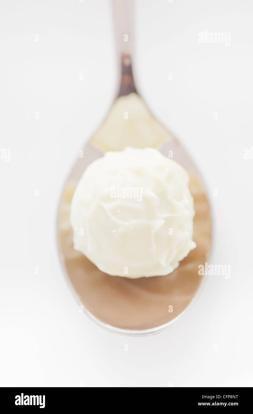 Closeup of a white chocolate truffle on a spoon Stock Photo - Alamy
