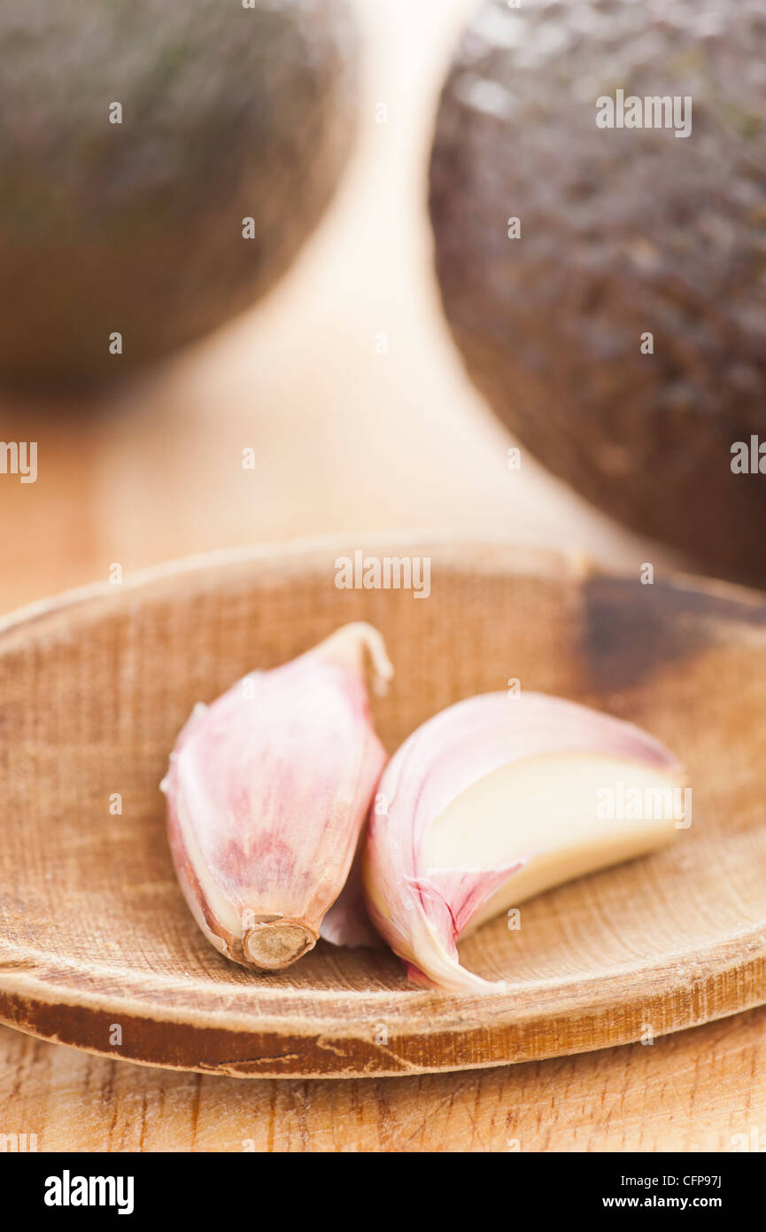 Closeup of two garlic cloves and avocados Stock Photo - Alamy