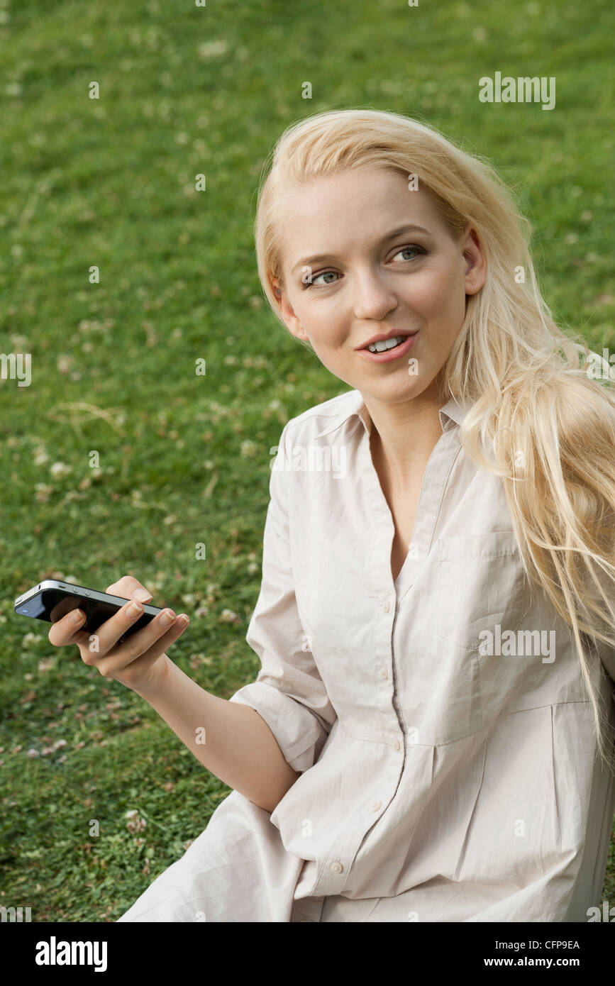 Young woman holding cell phone, portrait Stock Photo - Alamy