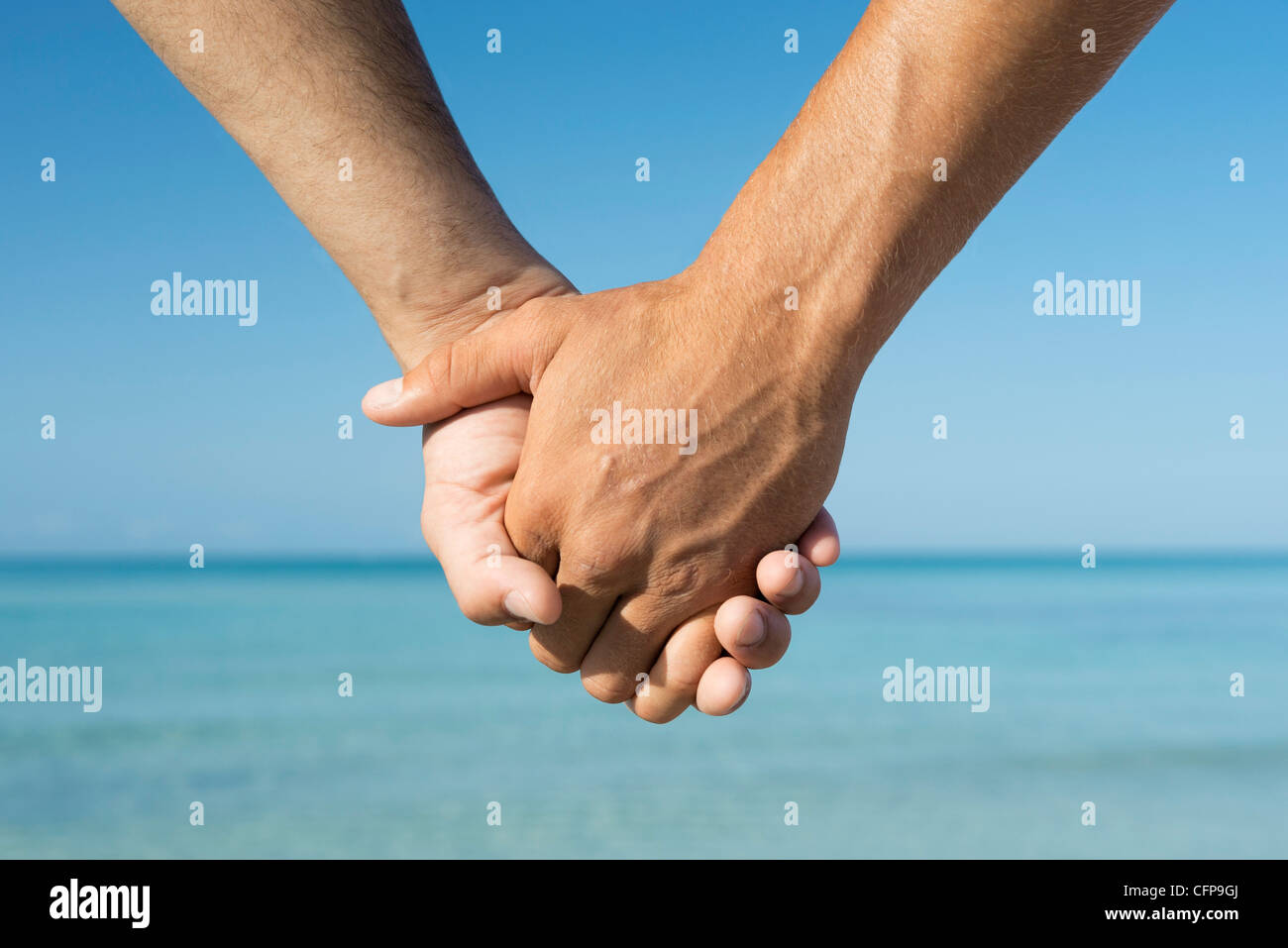 Two men hold hands hi-res stock photography and images - Alamy