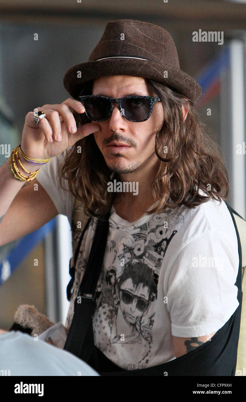 Cisco Adler arrives at LAX wearing a cast on his left arm, which he ...