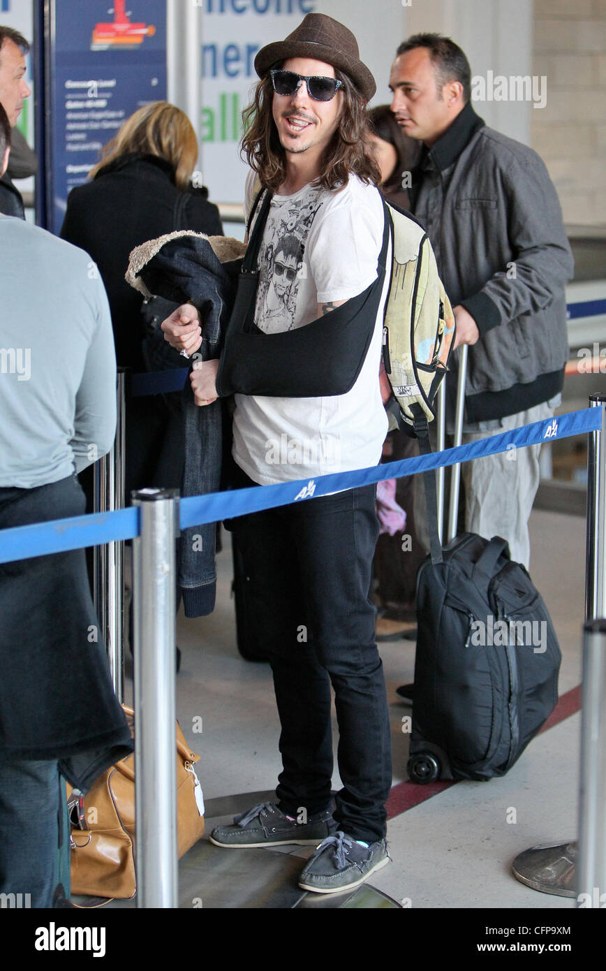 Cisco Adler arrives at LAX wearing a cast on his left arm, which he ...