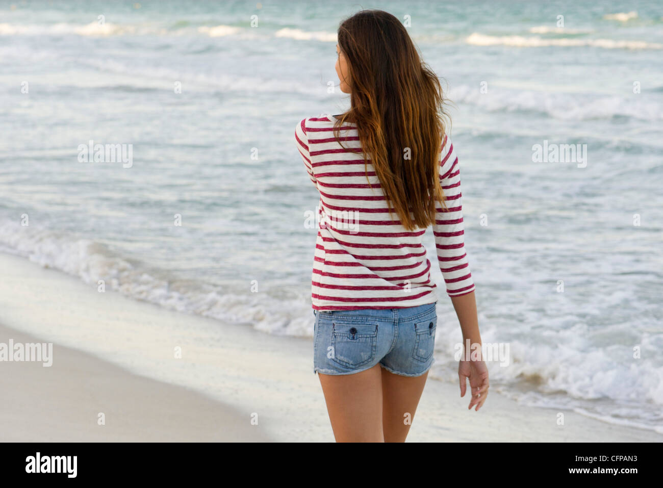 Woman walking on beach, rear view Stock Photo - Alamy