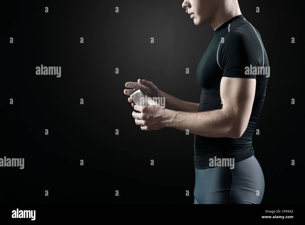 Male athlete applying chalk to hands Stock Photo - Alamy