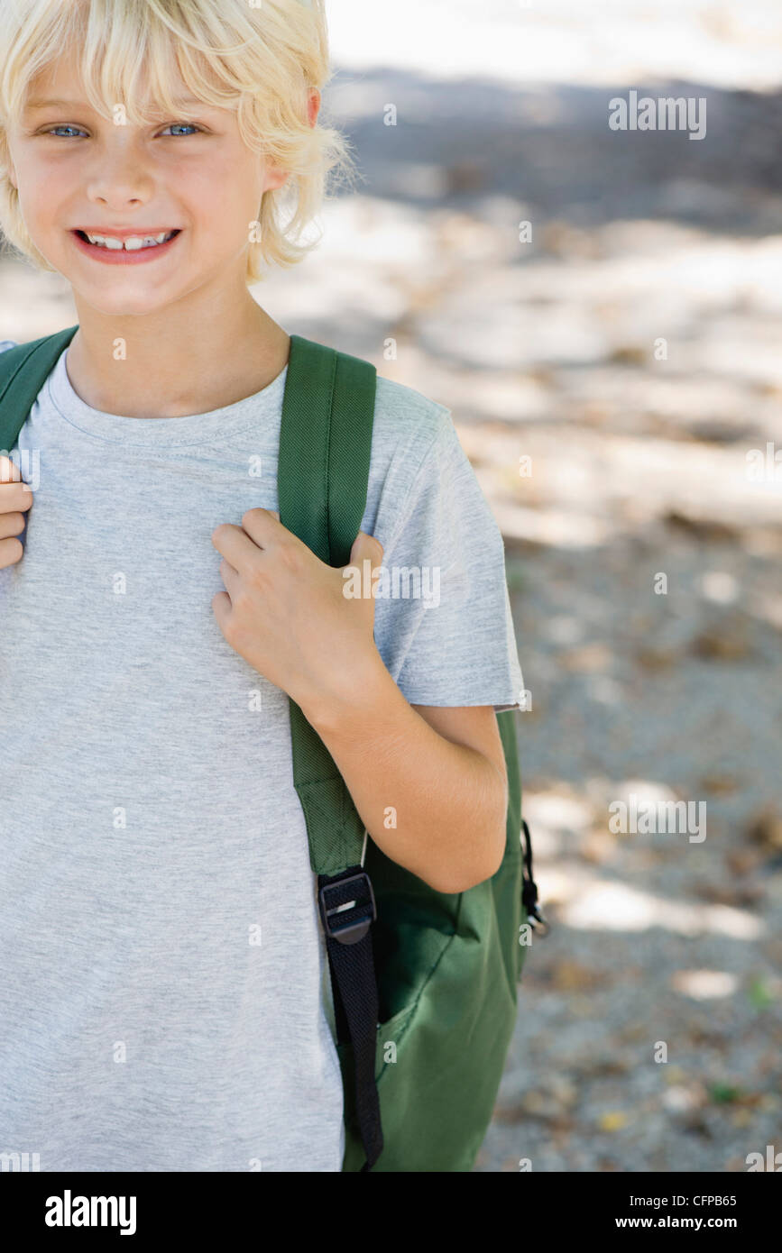 Boy carrying backpack, portrait Stock Photo - Alamy