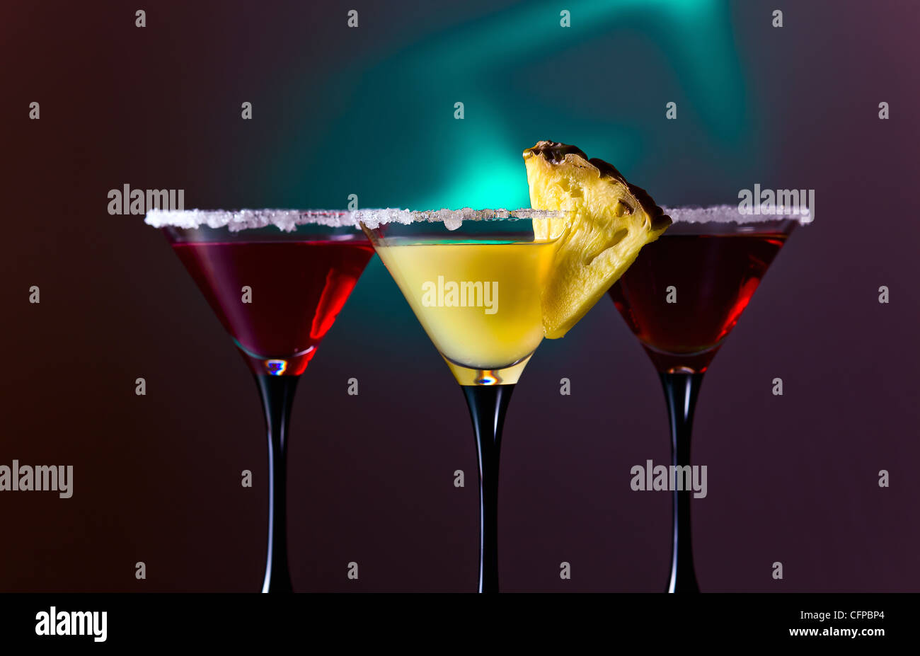 Three glasses with cocktail on a dark background Stock Photo - Alamy