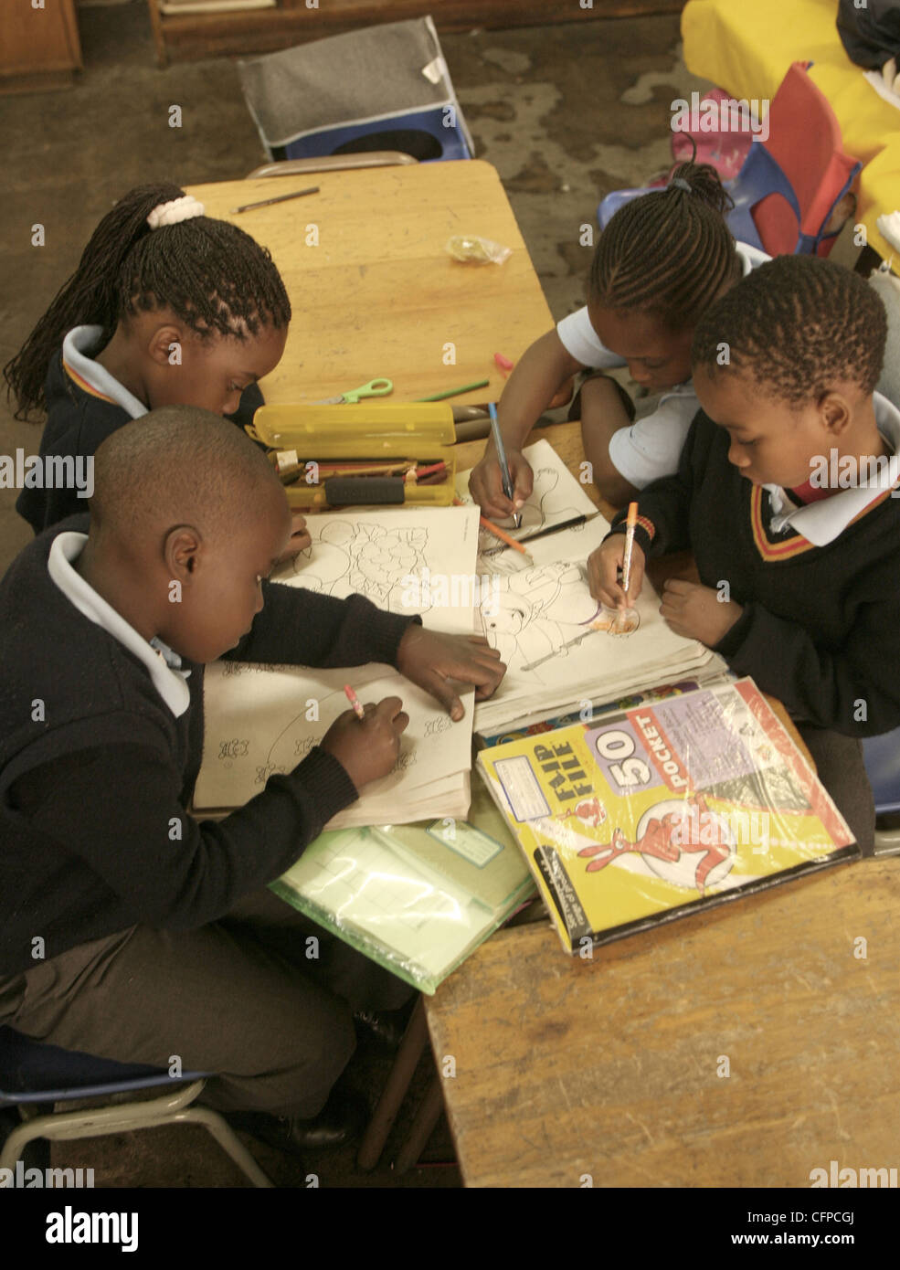Learners doing class work at a community school in Johannesburg ...