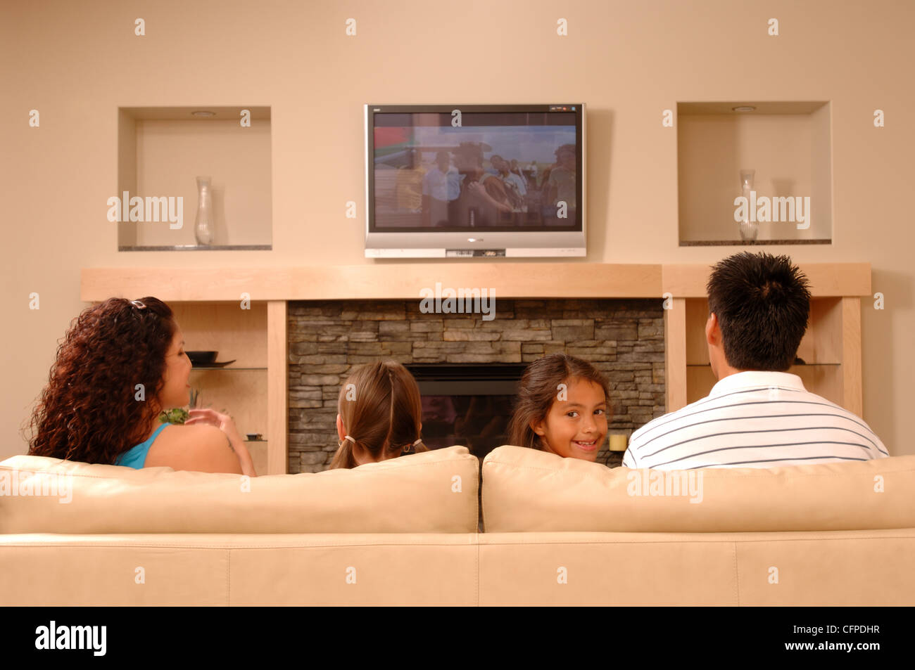 Family in Living Room Watching TV Stock Photo - Alamy