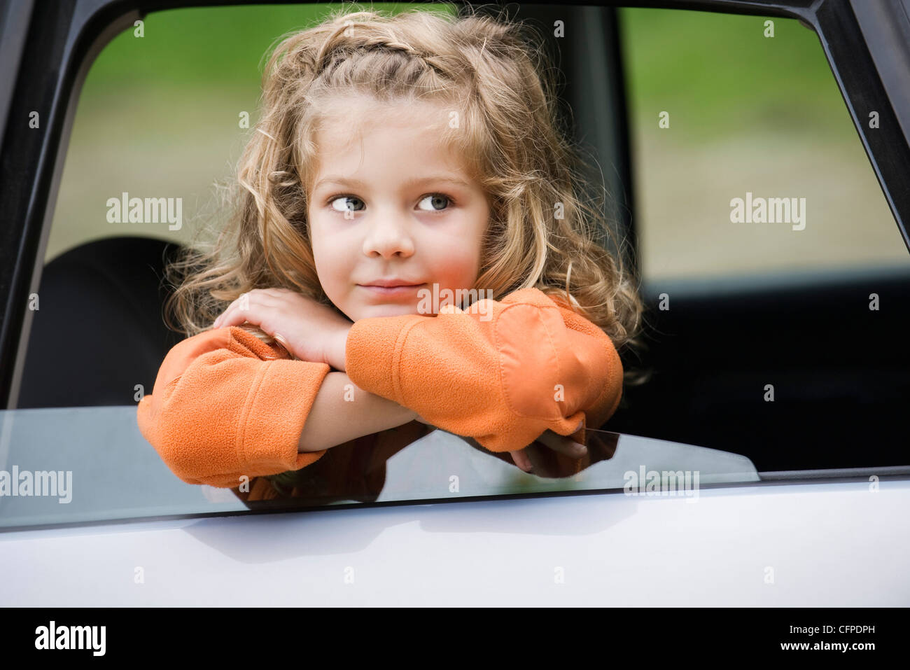 Little girl leaning out of car window, portrait Stock Photo - Alamy