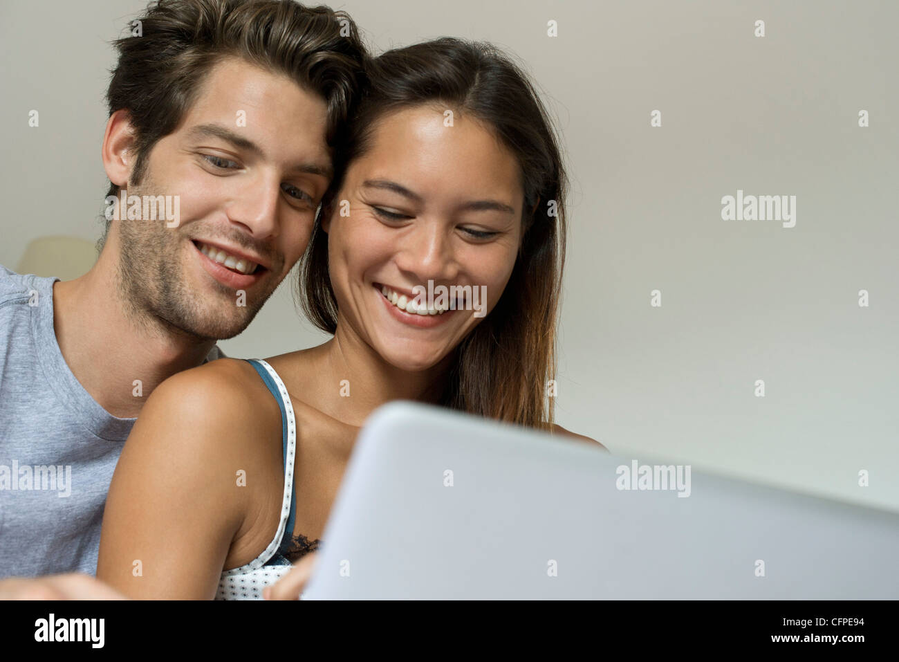 Young couple using laptop computer together, low angle view Stock Photo ...