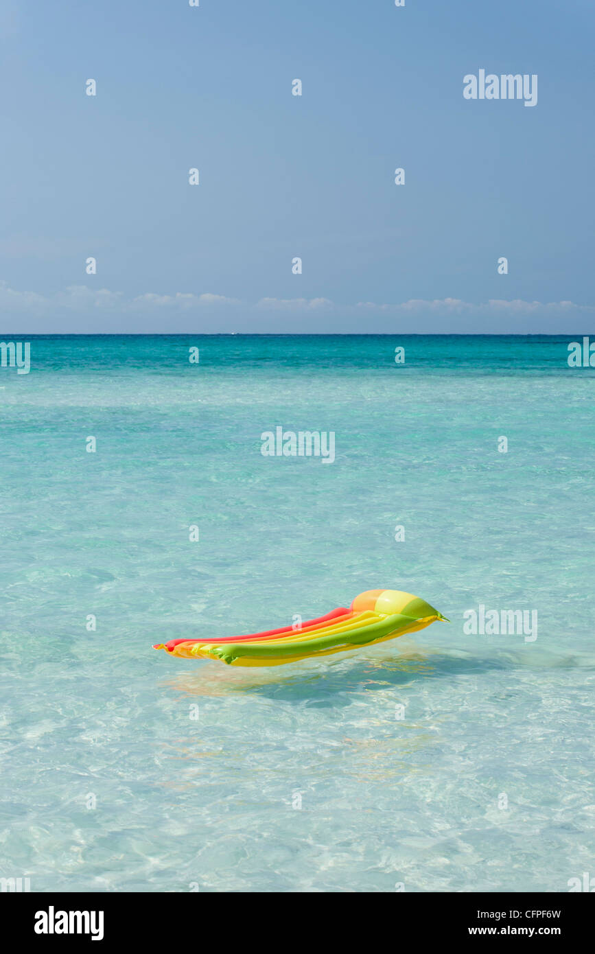 Pool raft floating in ocean Stock Photo - Alamy