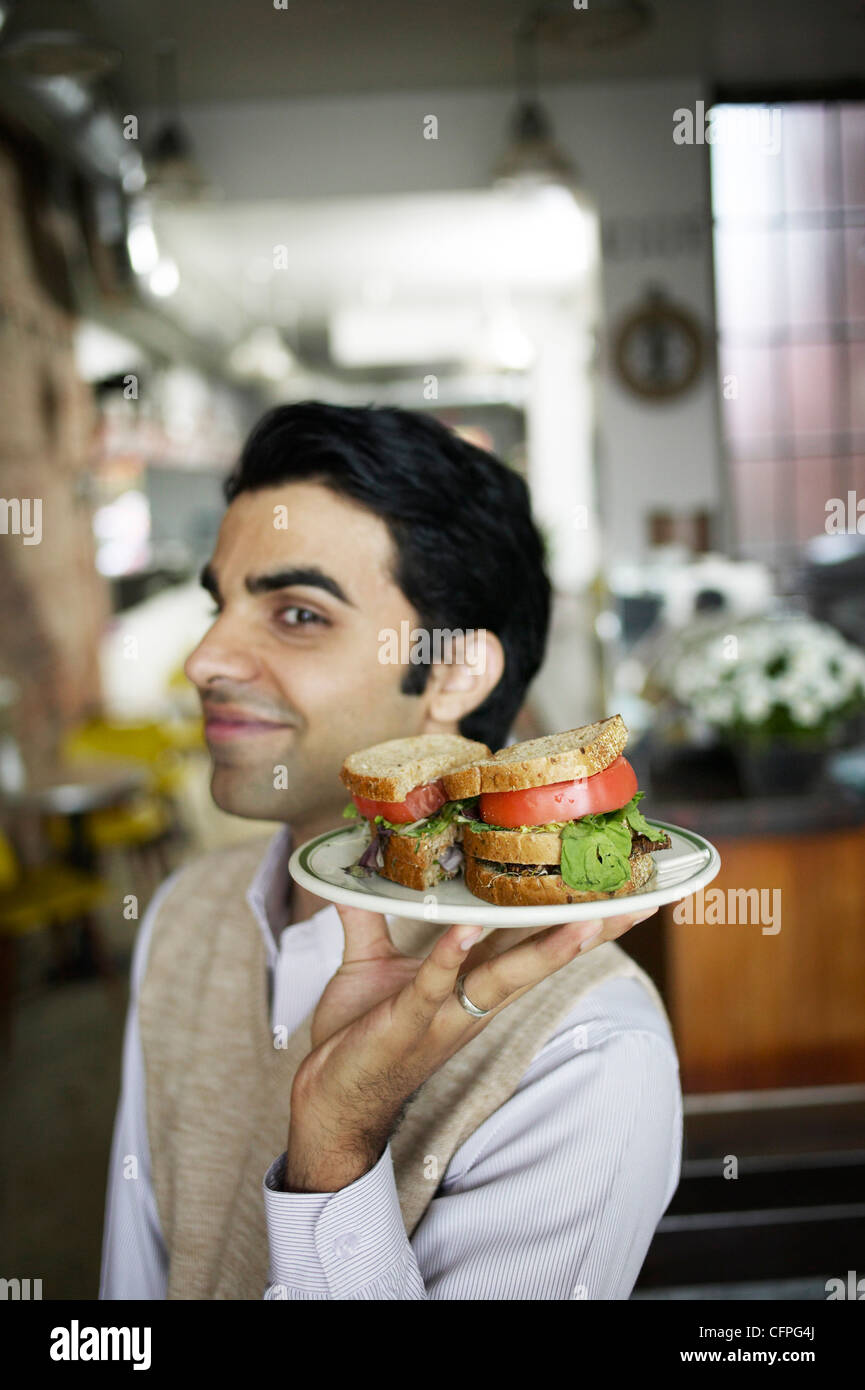 Waiter Holding Up Sandwich Stock Photo - Alamy