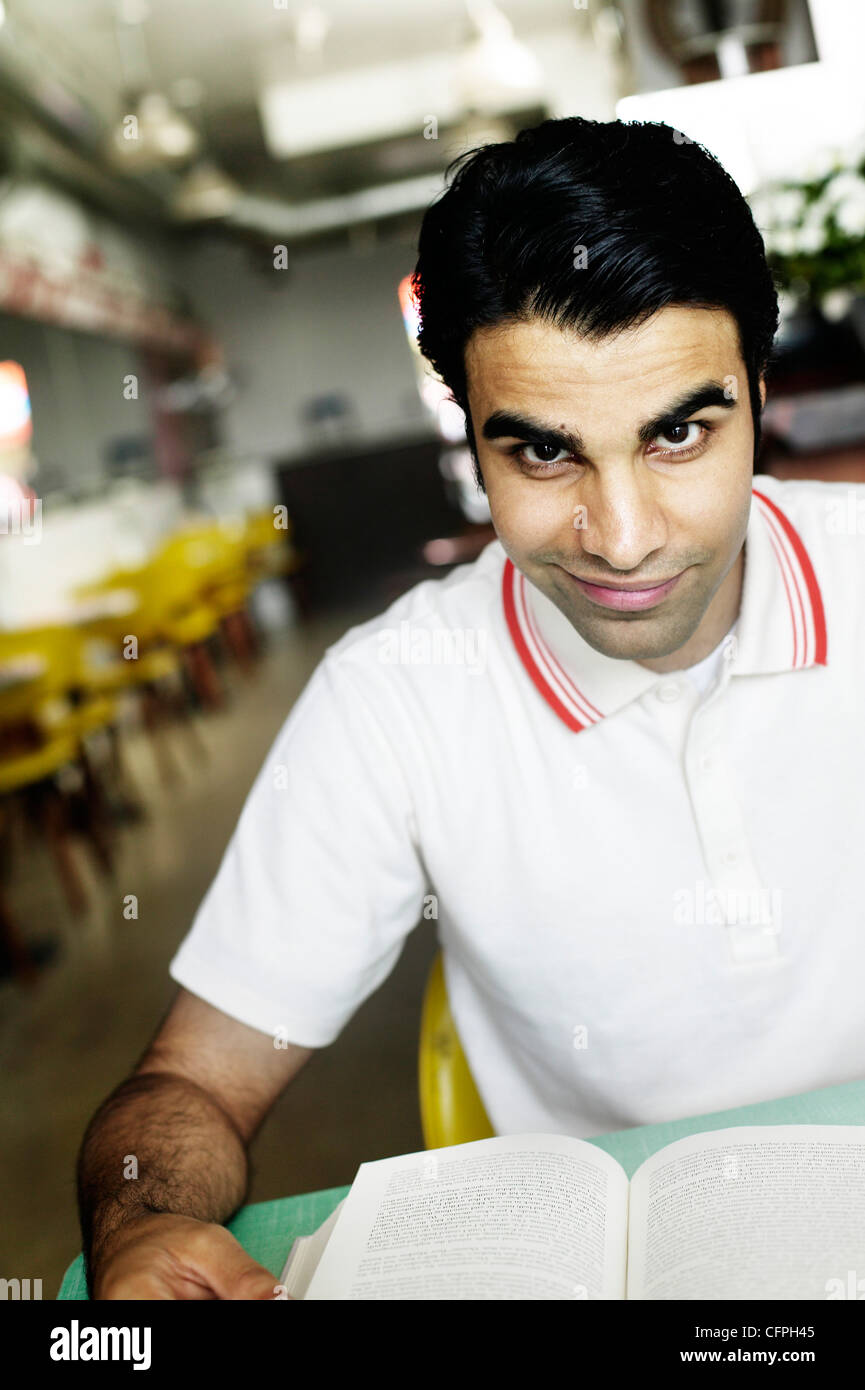 Man Reading Book in Restaurant Stock Photo - Alamy