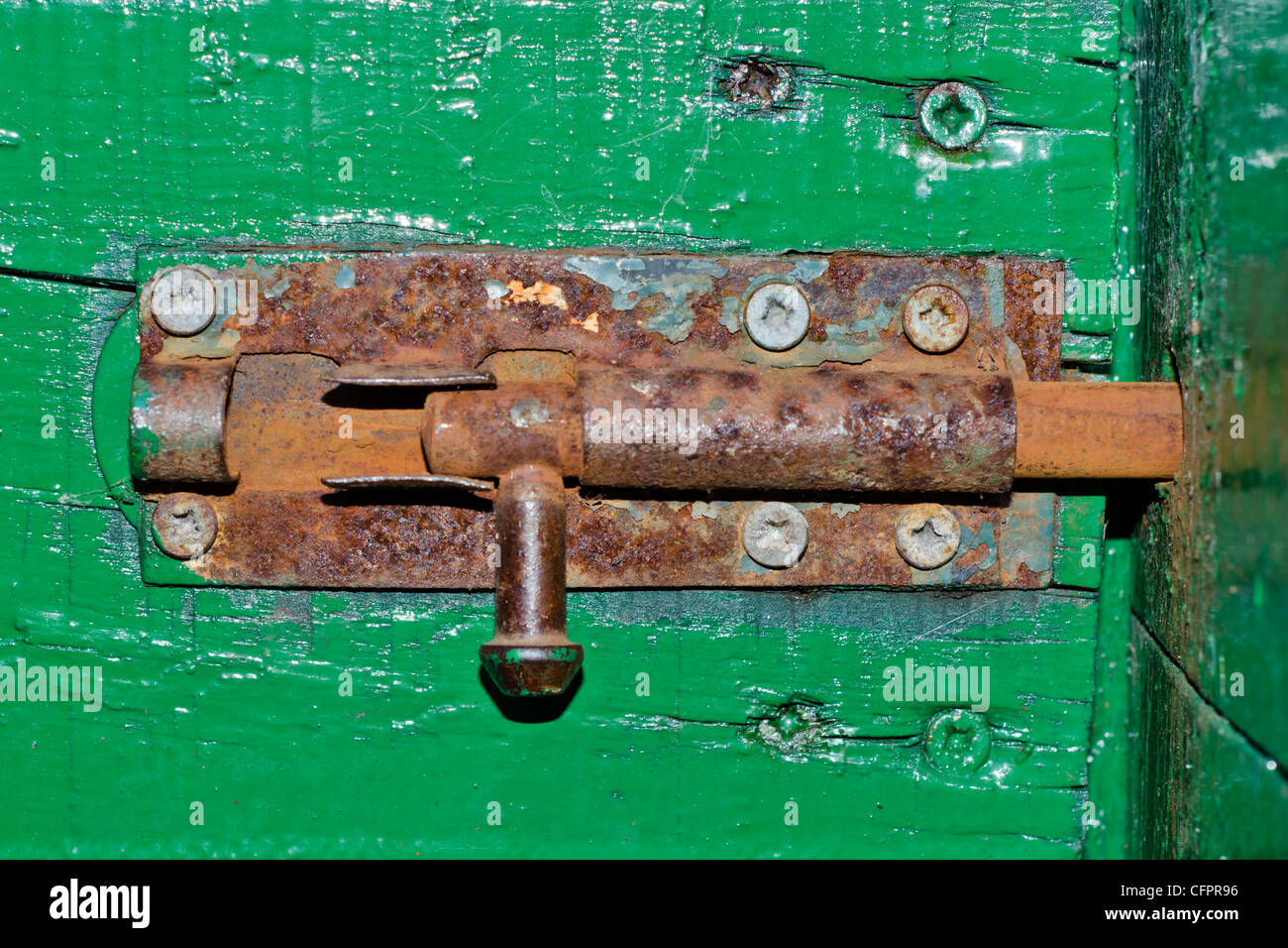 Rusty old bolt on an outside wooden door Stock Photo - Alamy