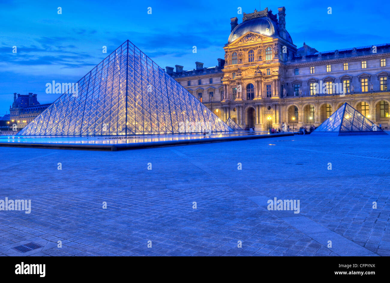 The Louvre at dusk with its glass pyramid entrance Stock Photo - Alamy