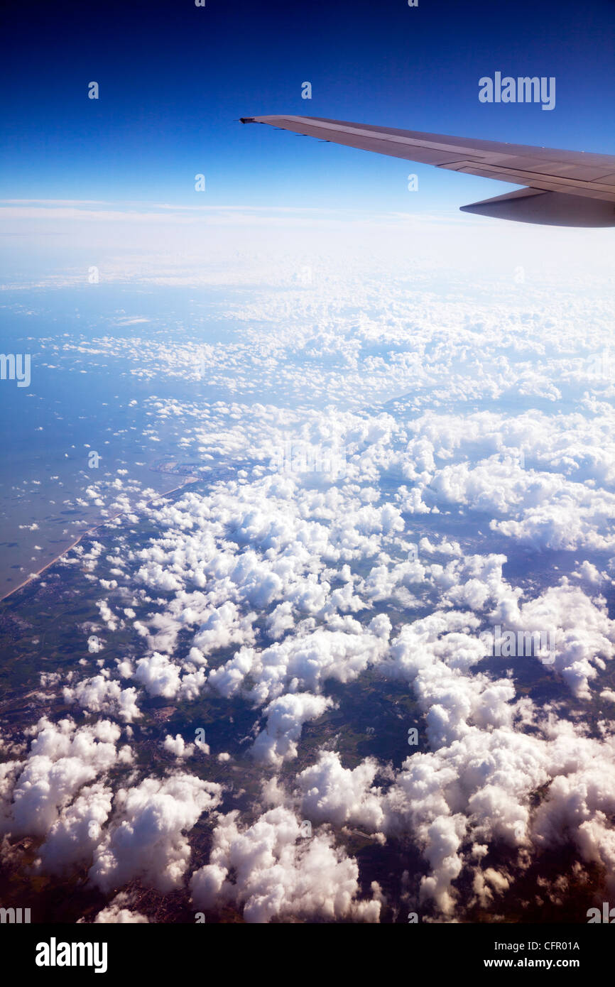 Onboard 747 airplane above the Alps wing tip showing above the clouds ...