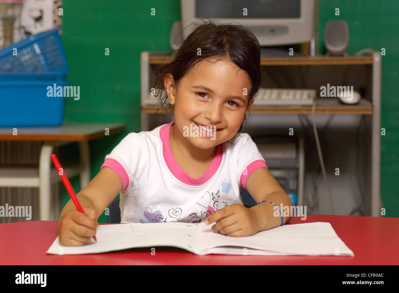 Girl at Desk in Classroom Stock Photo - Alamy