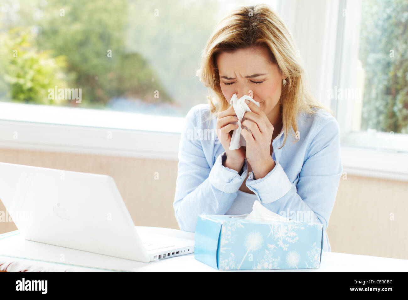 Girl with cold blowing nose Stock Photo - Alamy