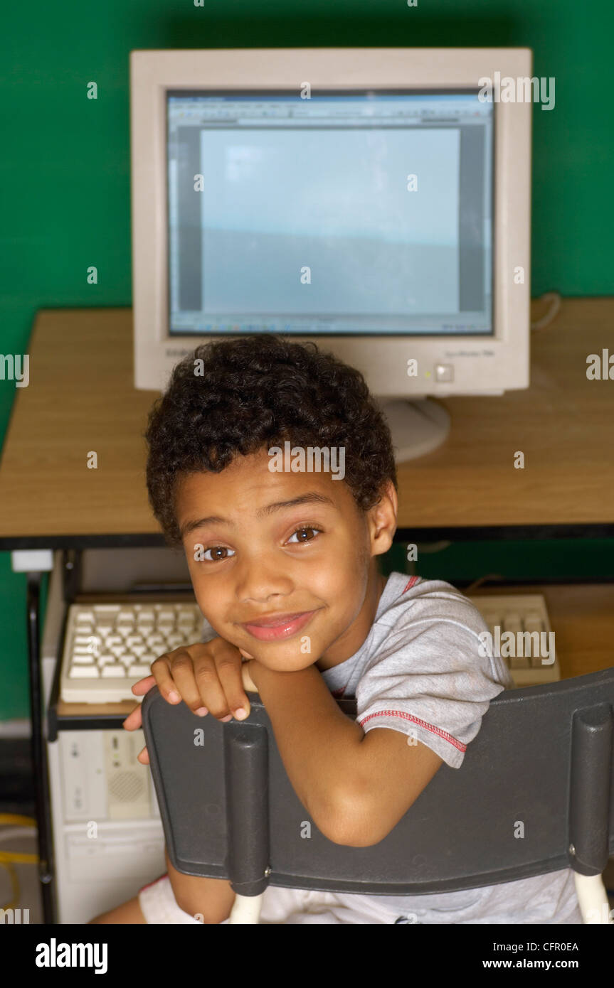 Boy Sitting at Desk with Computer Stock Photo - Alamy