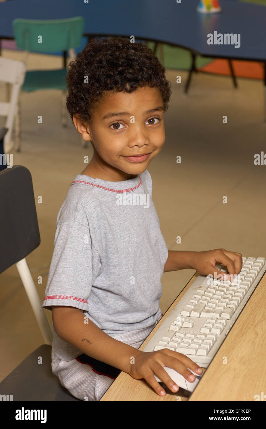 Boy Sitting at Keyboard Stock Photo - Alamy