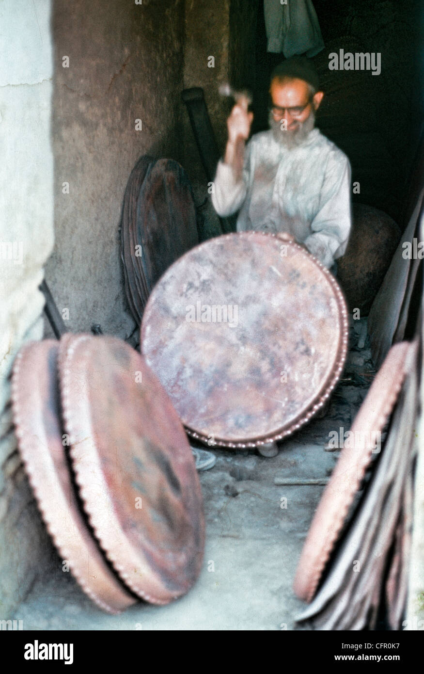 IRAN, ISFAHAN: Iranian copper artisan forms a decorative edge on a ...