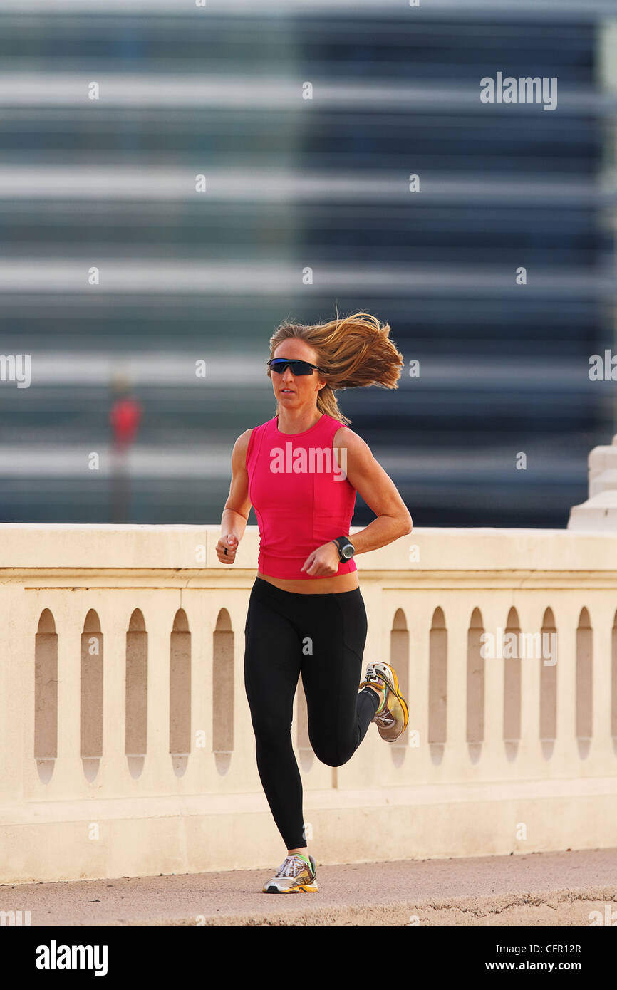 A beautiful athletic woman running in an urban environment Stock Photo ...