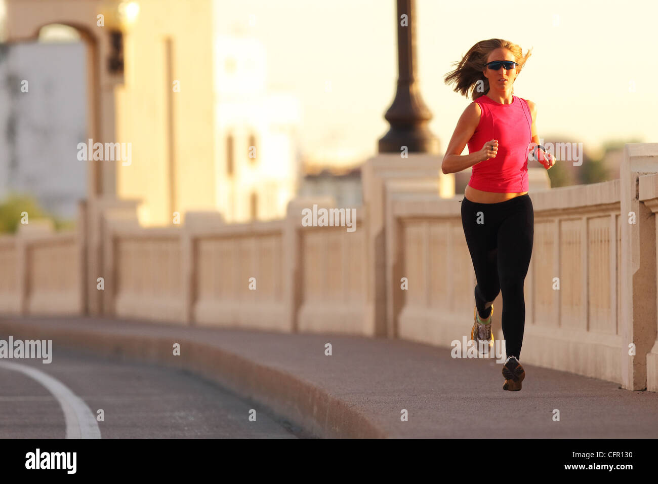 A beautiful athletic woman running in an urban environment Stock Photo ...