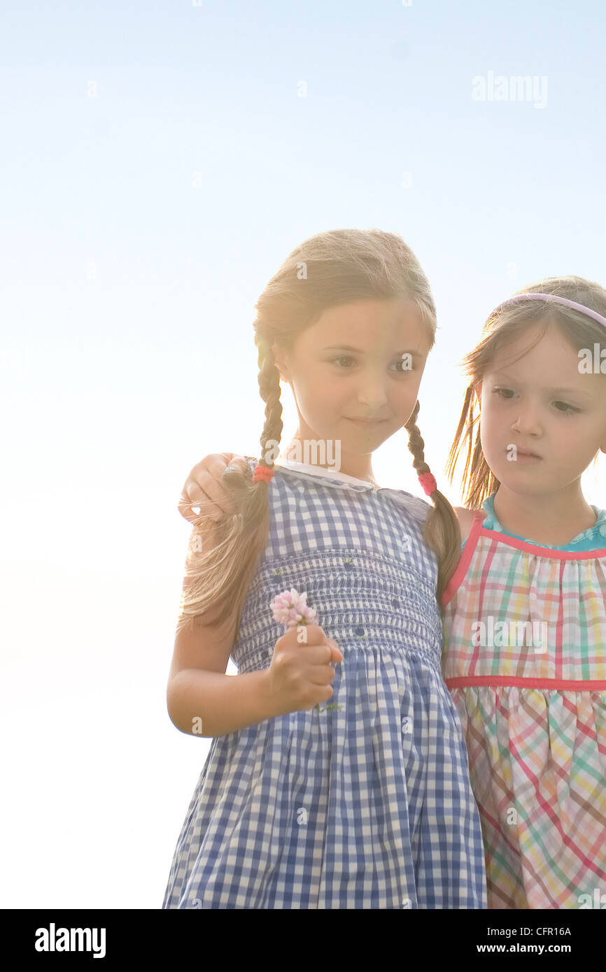 Young Girls with Arms Around Each Other Stock Photo - Alamy