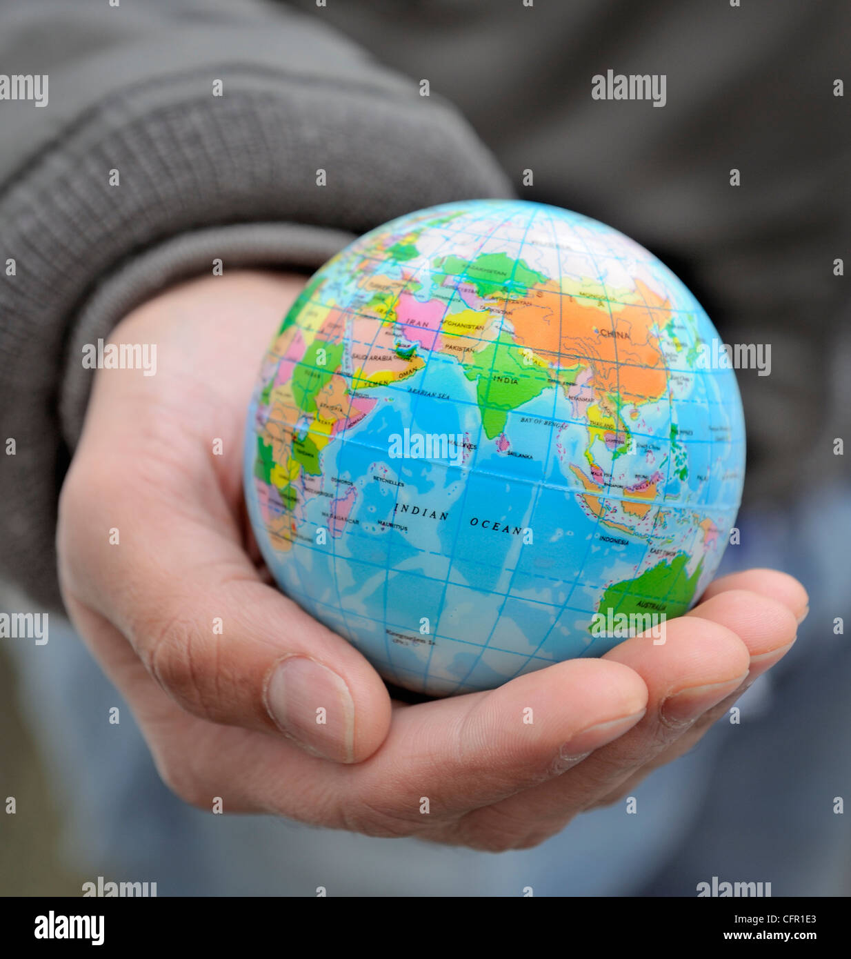 Close-up of globe in hand of Indian man Stock Photo - Alamy